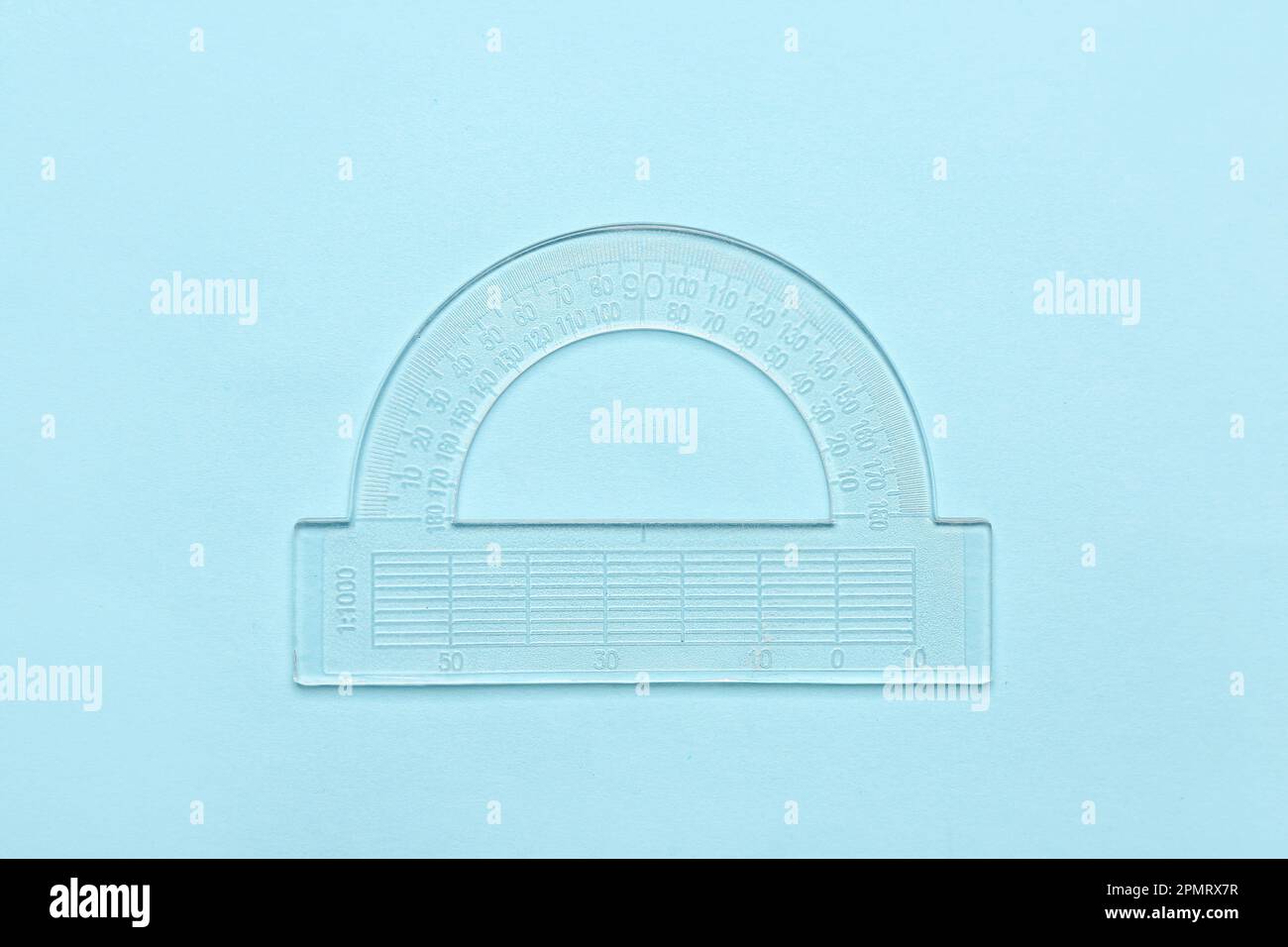 Transparent plastic protractor on blue background Stock Photo - Alamy