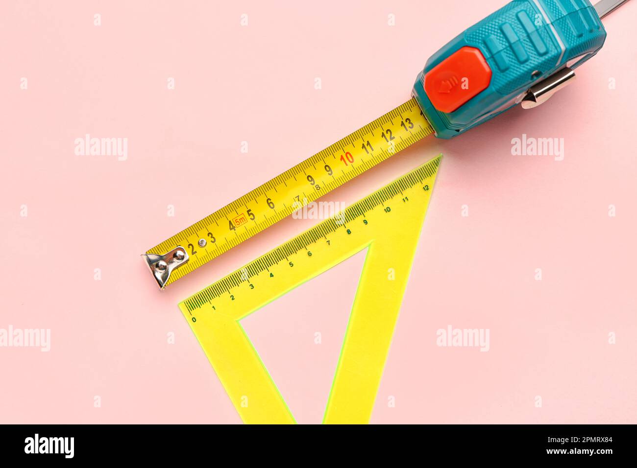 Measuring tape and triangle ruler on pink background Stock Photo - Alamy