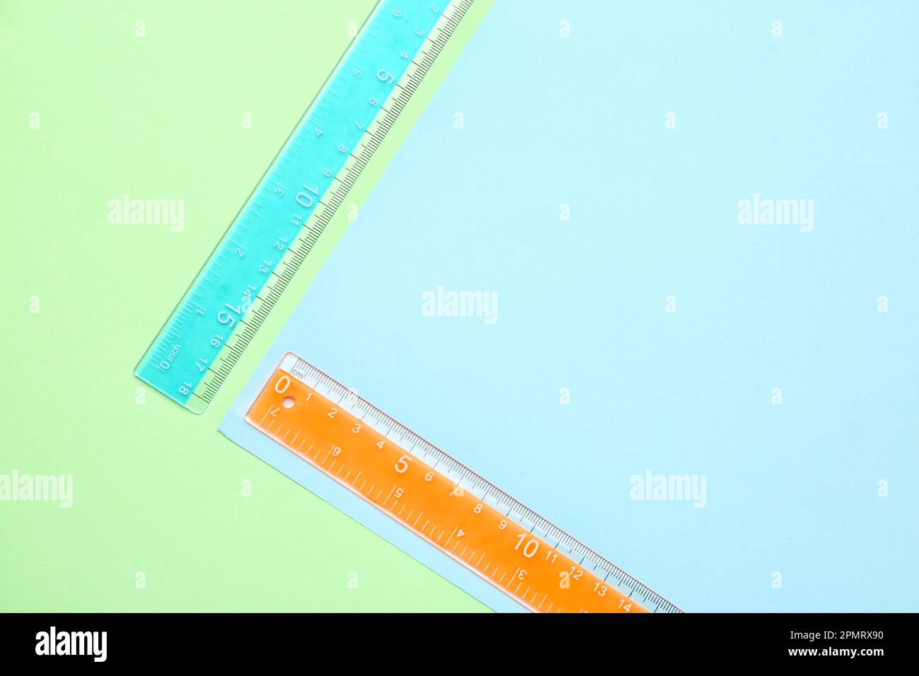 Blue and orange plastic rulers on color background Stock Photo - Alamy
