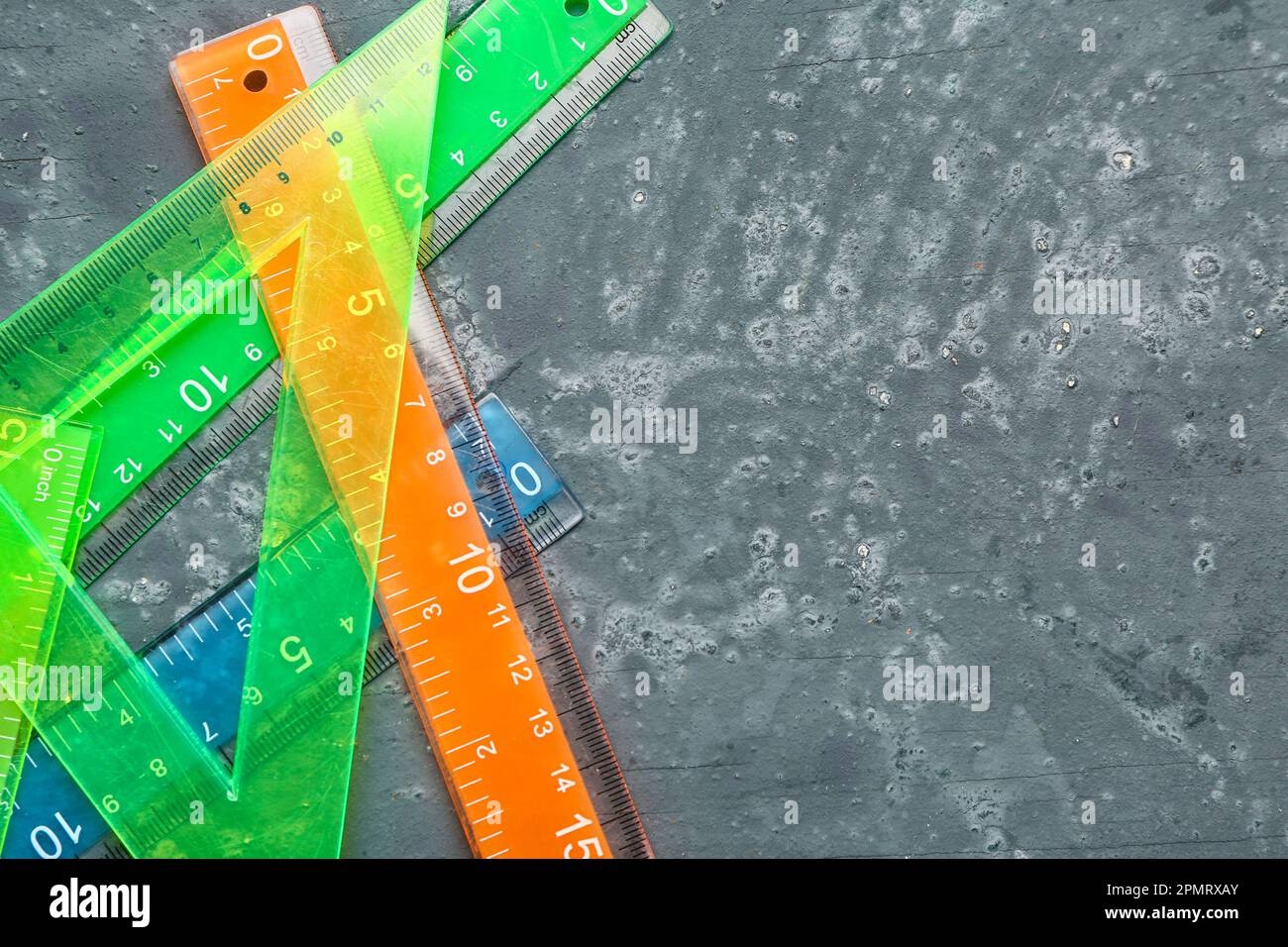 Colorful straight and triangle plastic rulers on grunge background ...