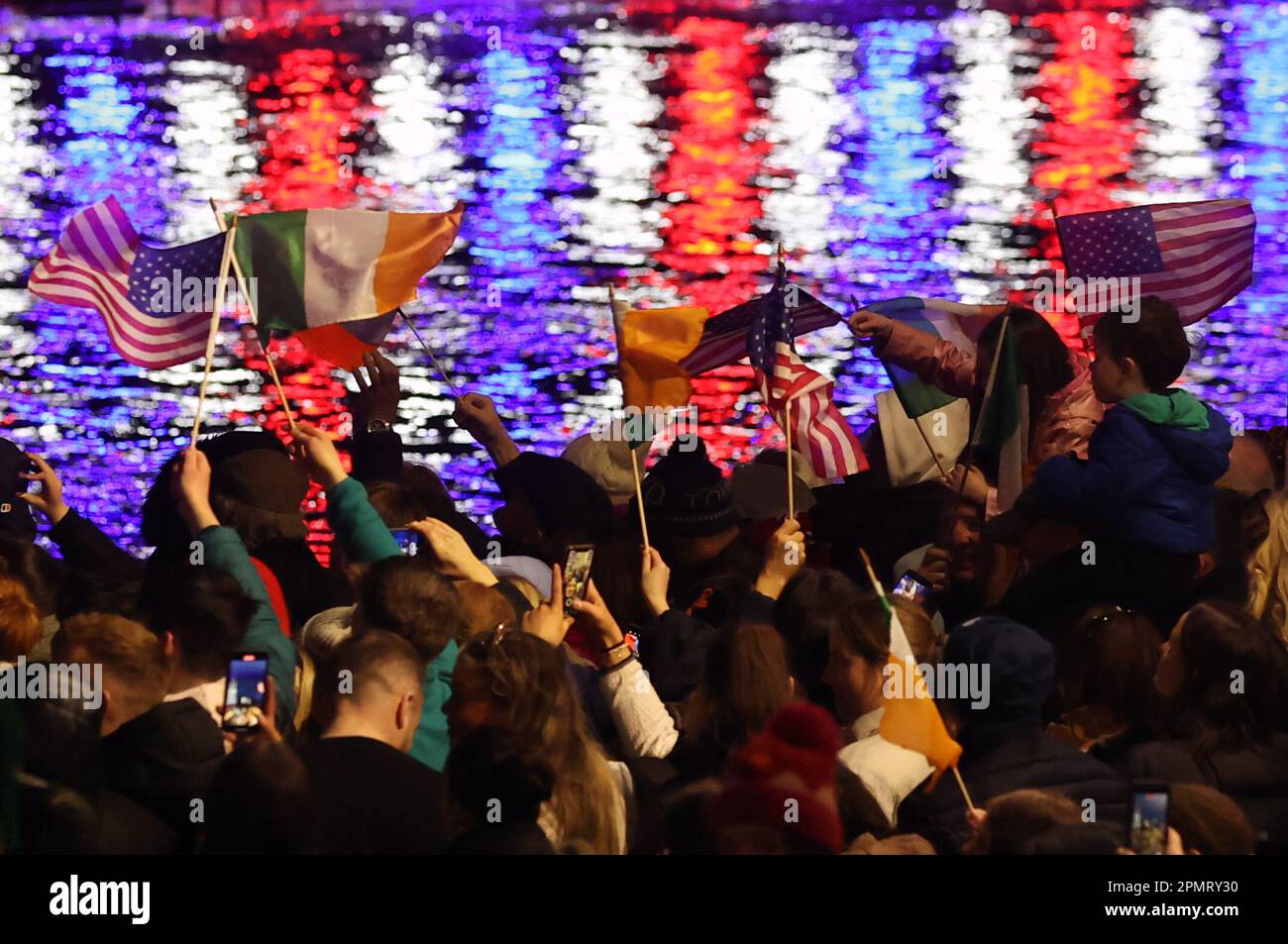People watch US President Joe Biden deliver a speech at St Muredach's ...