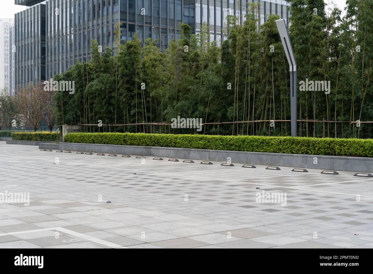 empty concrete ground floor with modern office building exterior in ...