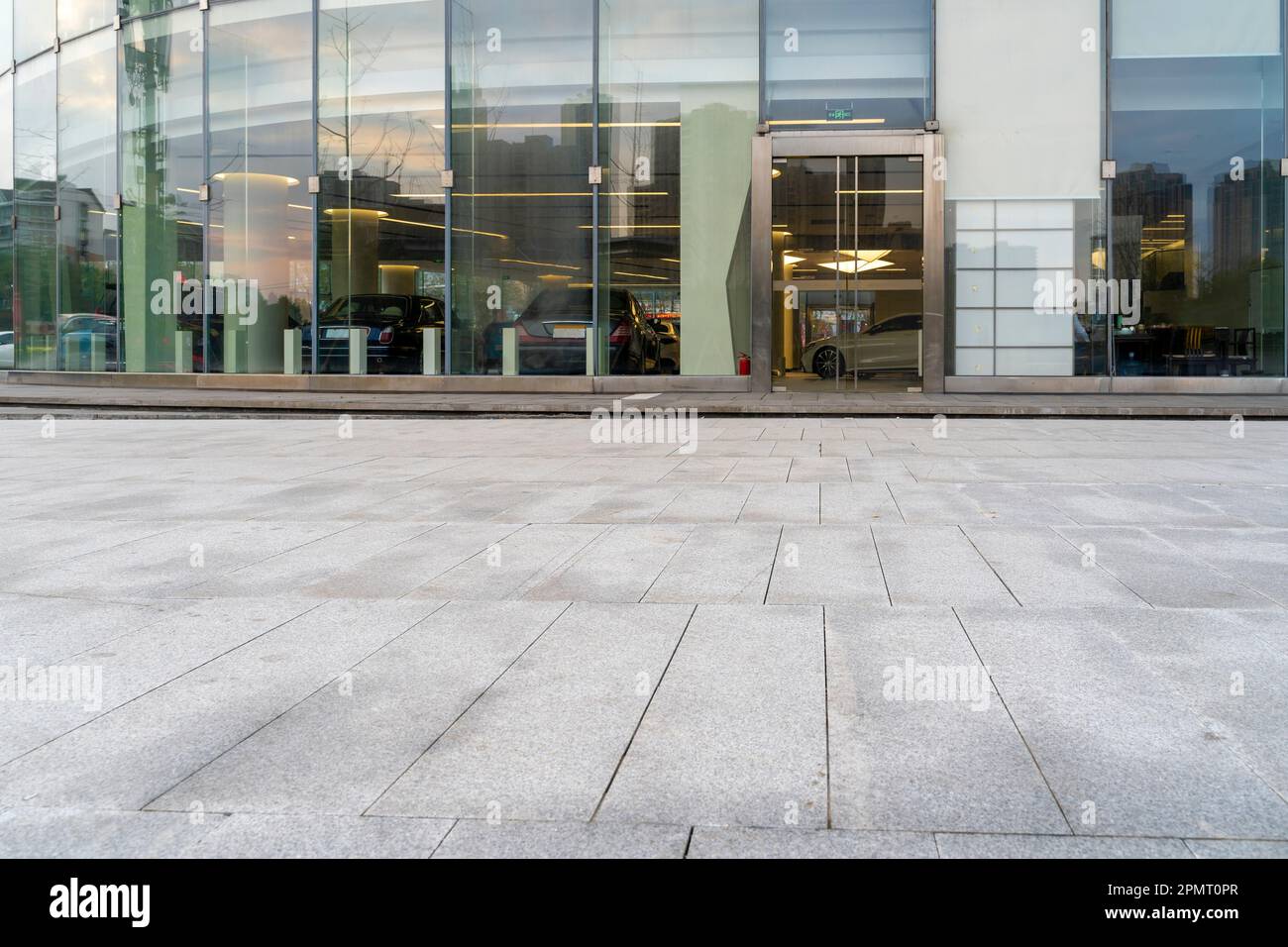 empty concrete ground floor with modern office building exterior in ...