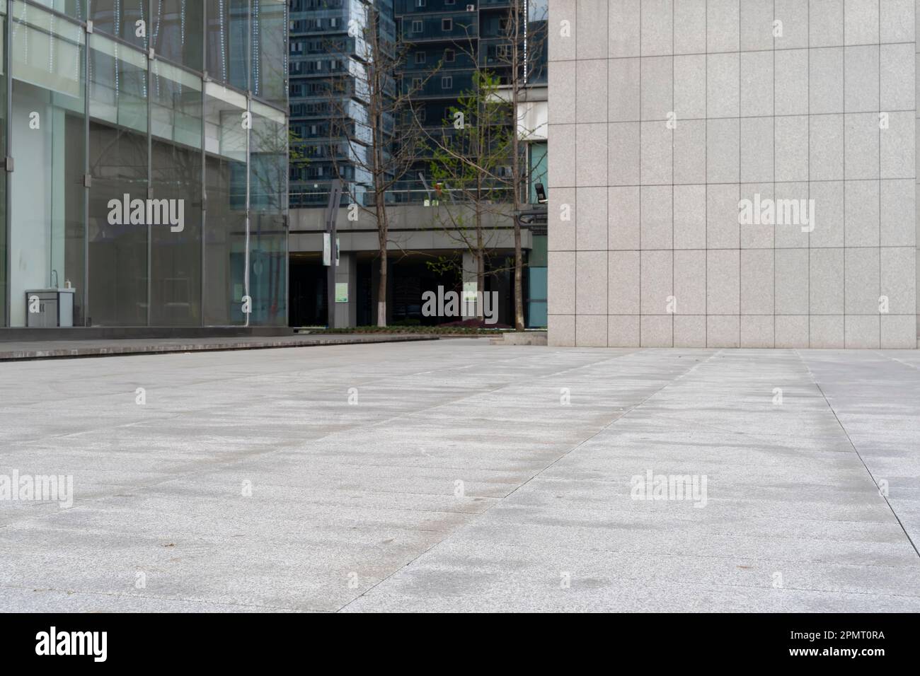 empty concrete ground floor with modern office building exterior in ...