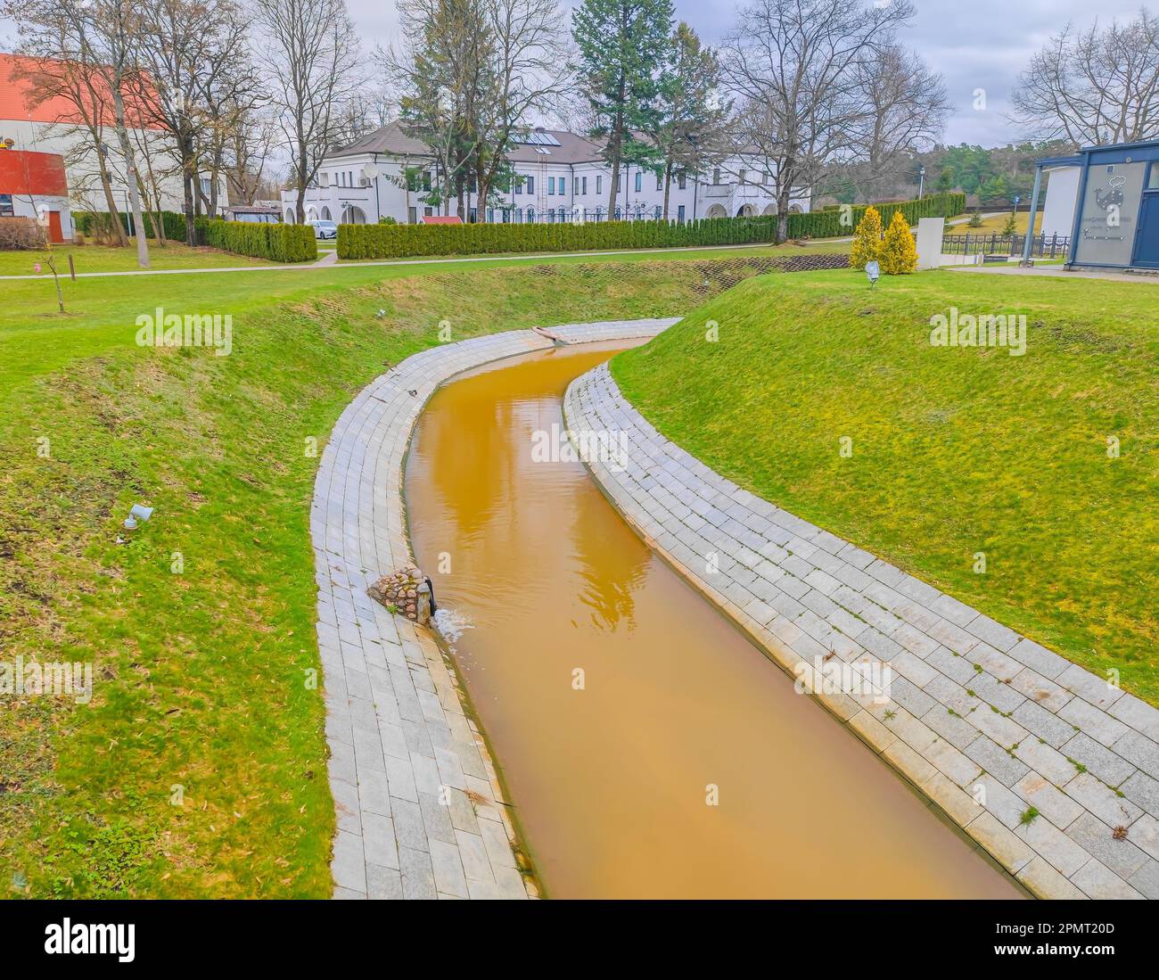 Environmental pollution of small river in city. Water pollution. Brown ...