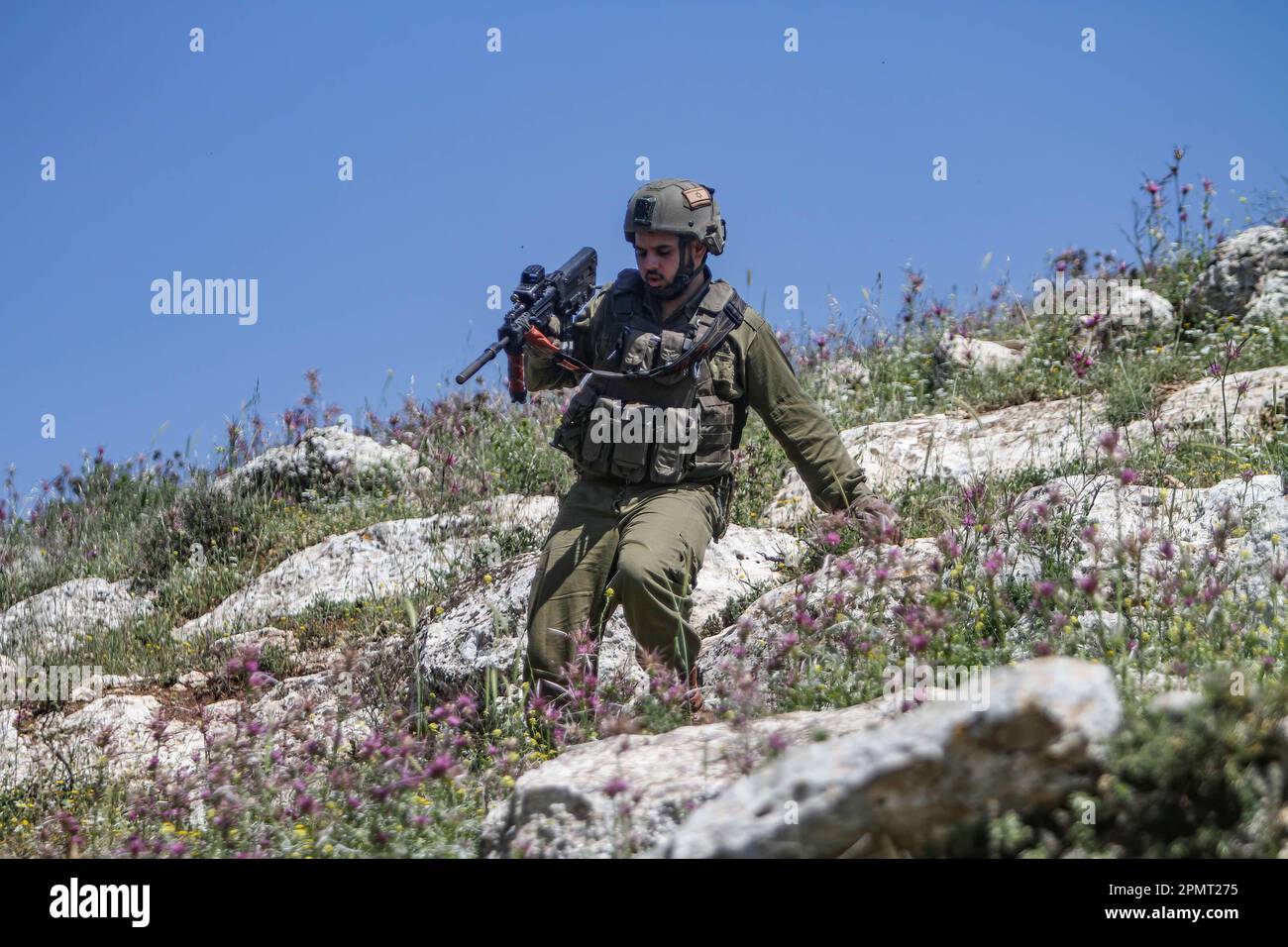 Nablus, Palestine. 14th Apr, 2023. An Israeli soldier takes position ...