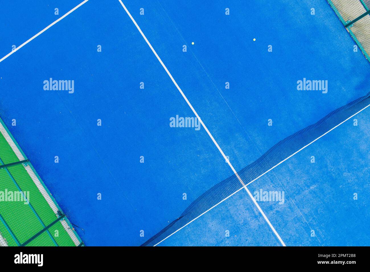 An aerial view of a bright blue tennis court with plenty of copy space ...