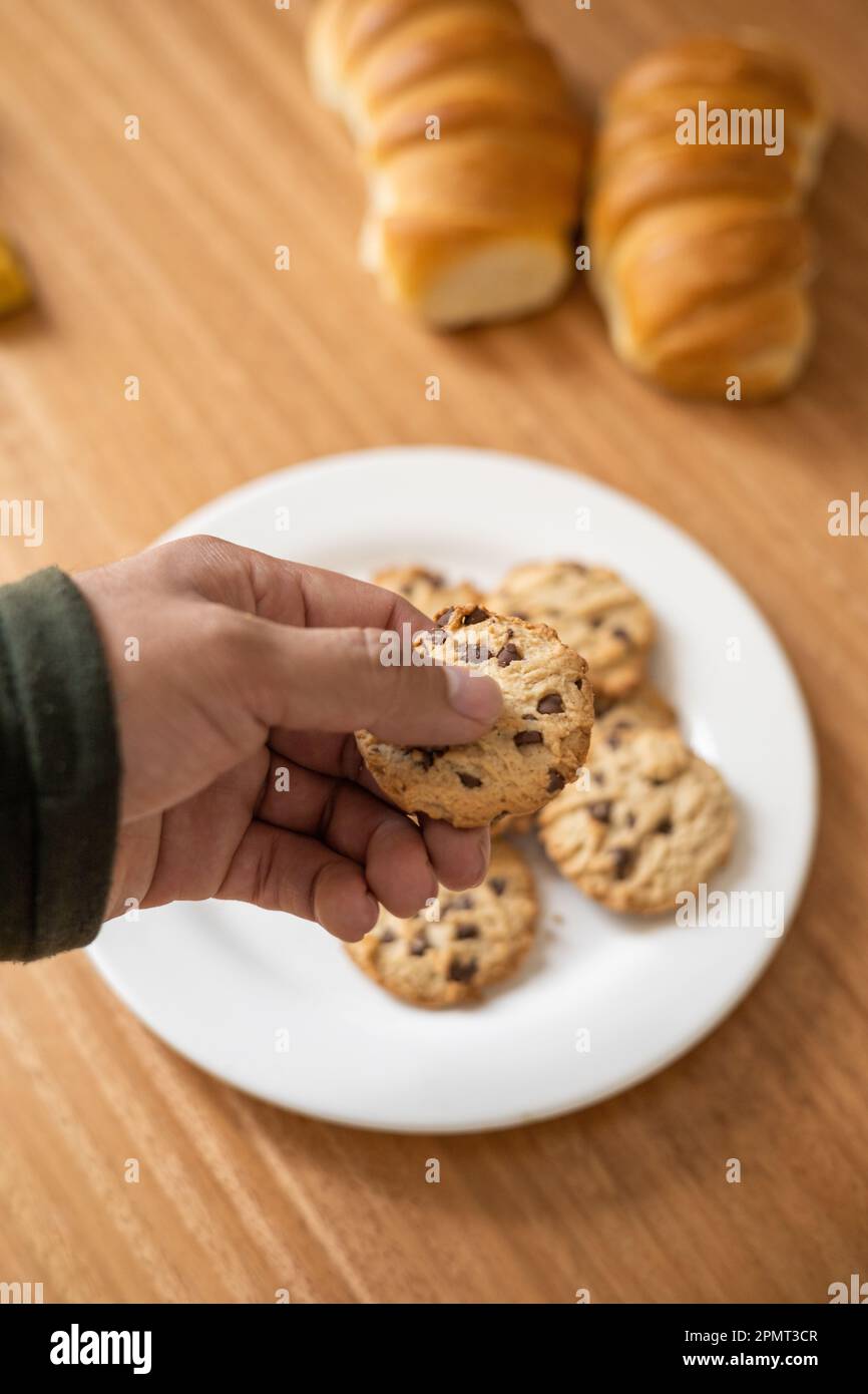 eating a chocolate chip cookie sweet food, studio with breads in the ...