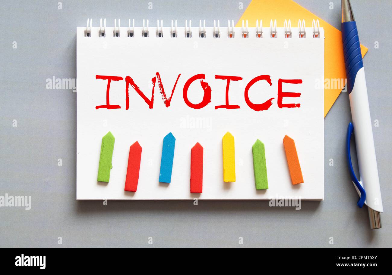 The word invoice on torn paper on red notepad Stock Photo - Alamy