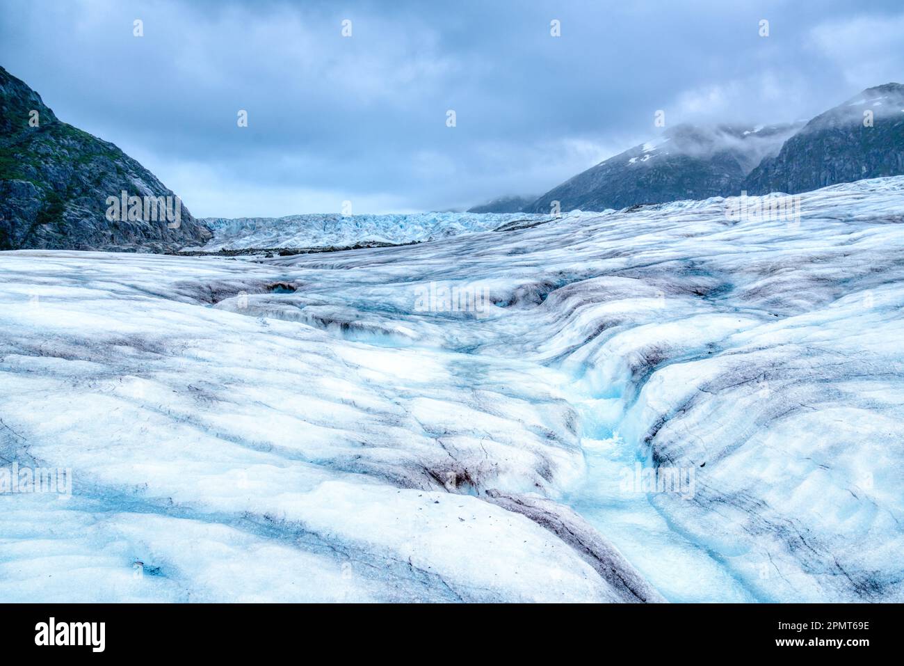 Melting glacier ice in the Mendenhall Glacier in Alaska forms a winding ...