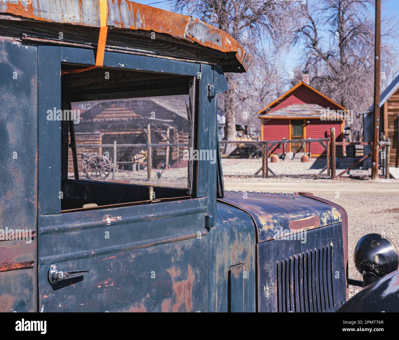 Looking through the window of a vintage antique truck you see old log ...