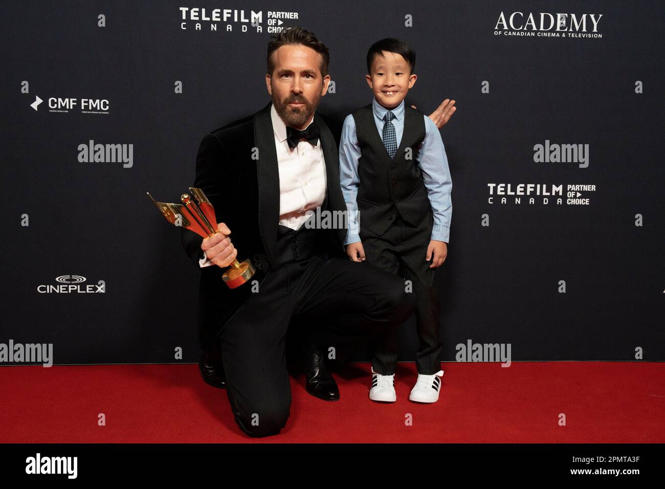 Toronto, Canada. 14th Apr, 2023. Ryan Reynolds poses with Everett Ho, a Sick Kids hero, after ...