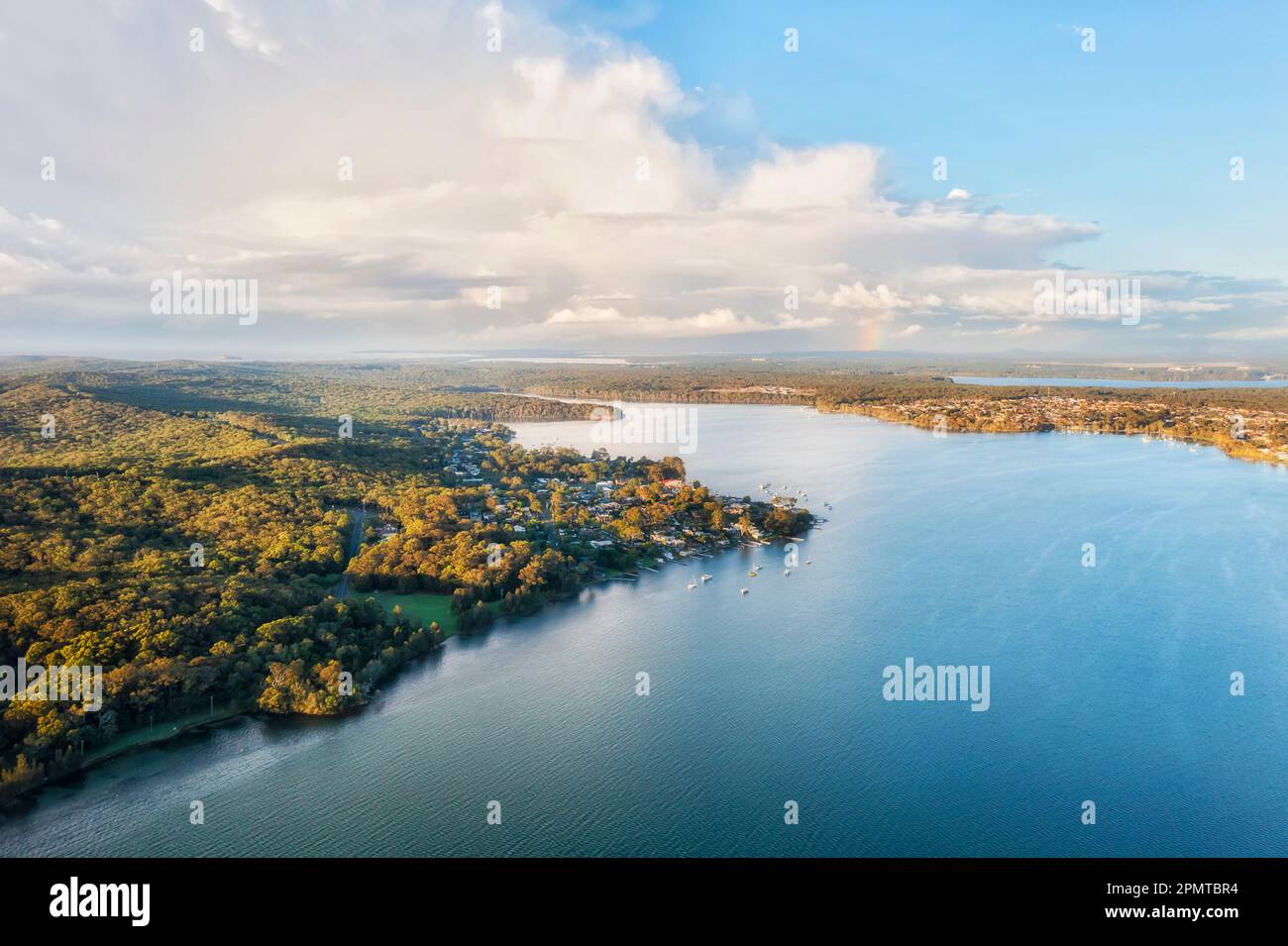 Scenic calm Lake Macquarie at Nords wharf coastal town with distant ...