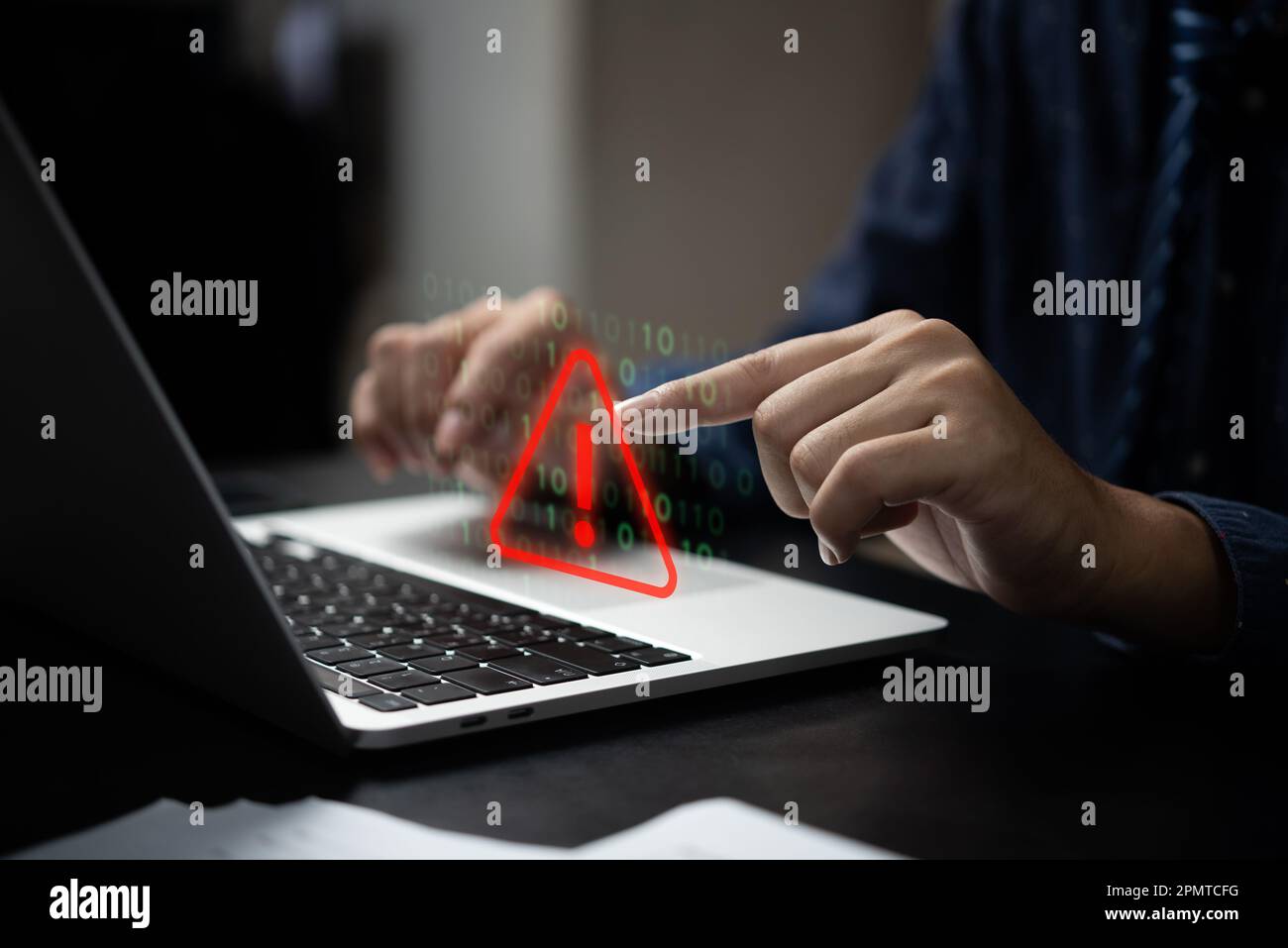 Businessman programmer, developer using laptop computer with triangle caution warning sign for ...