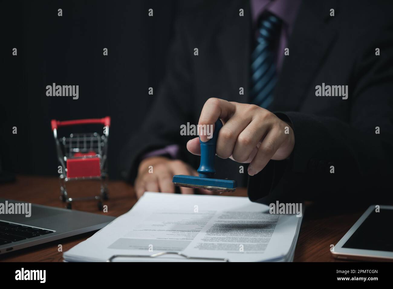 Man hand stamping approval signing on document or paperwork contract at ...