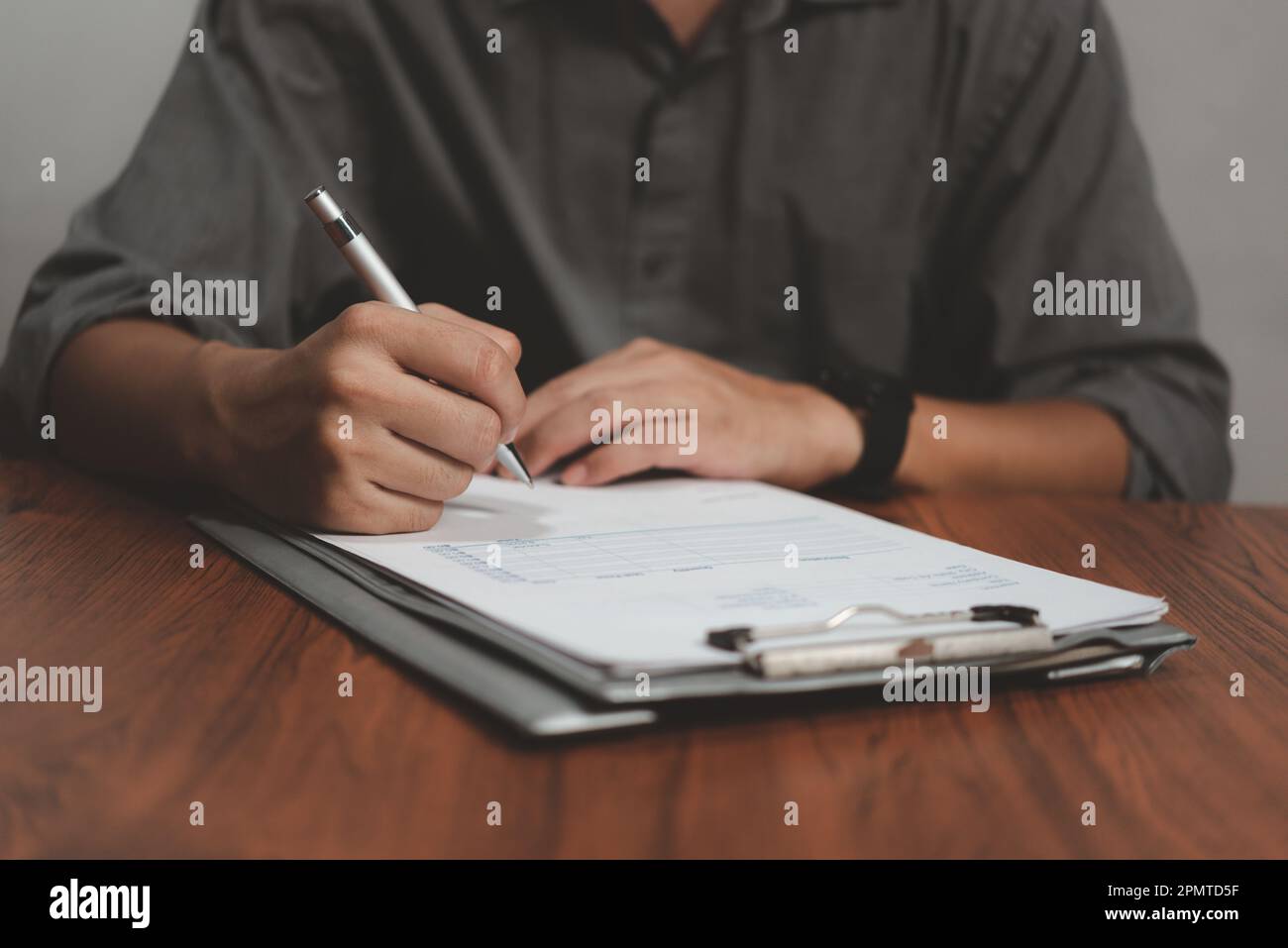 Businessman signs contract investment professional documents with a pen ...