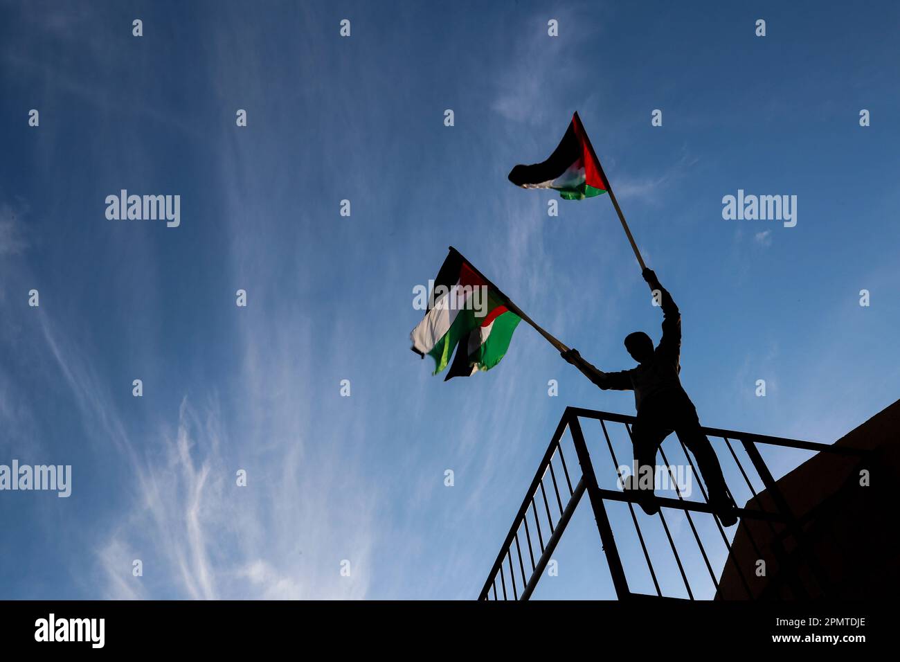 A Palestinian boy waves Palestinian flags as he attends a rally marking ...
