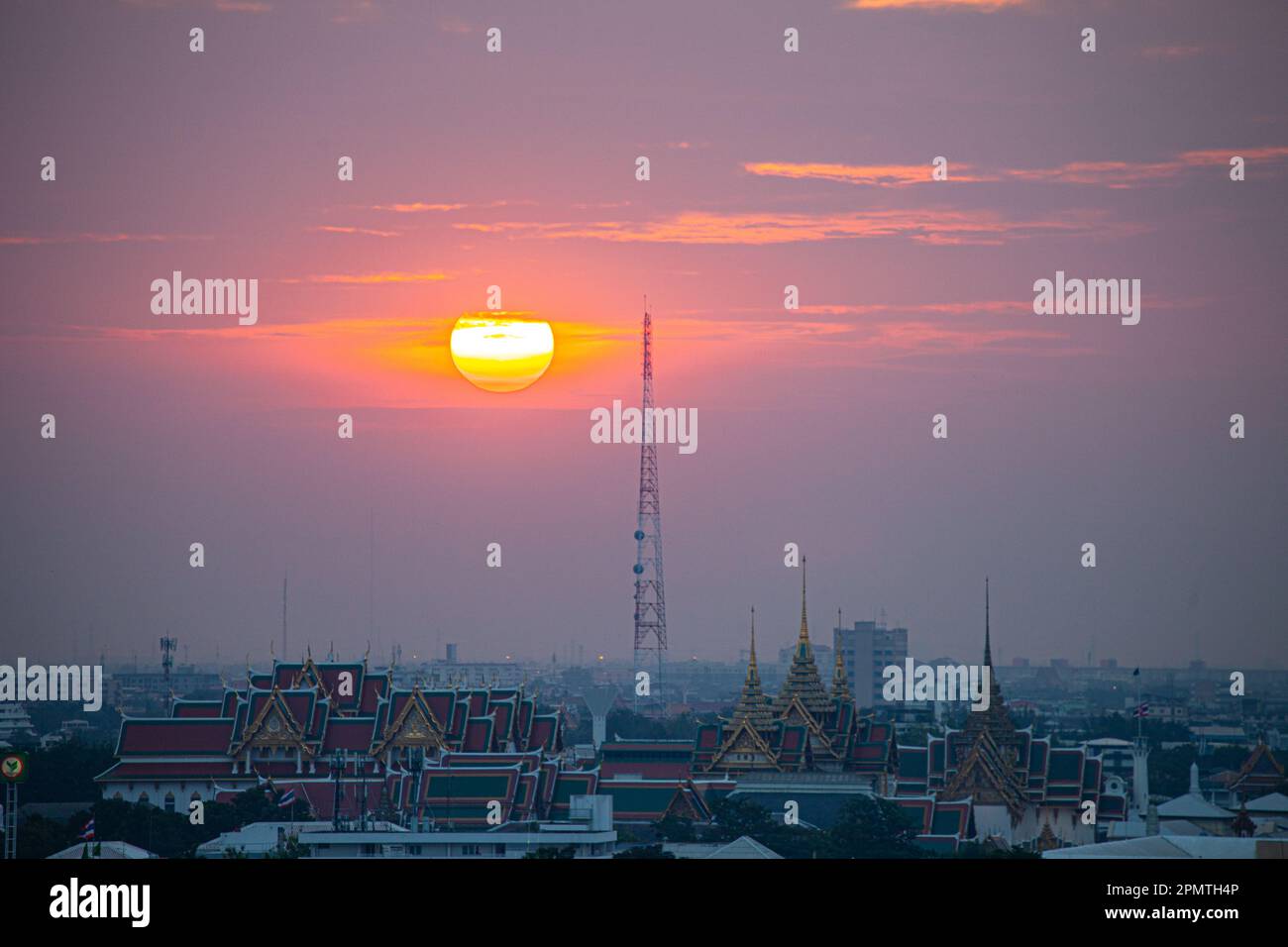 The red sun beside a huge signal tower in the heart of Bangkok ...
