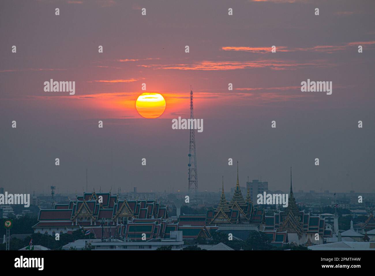 The red sun beside a huge signal tower in the heart of Bangkok ...
