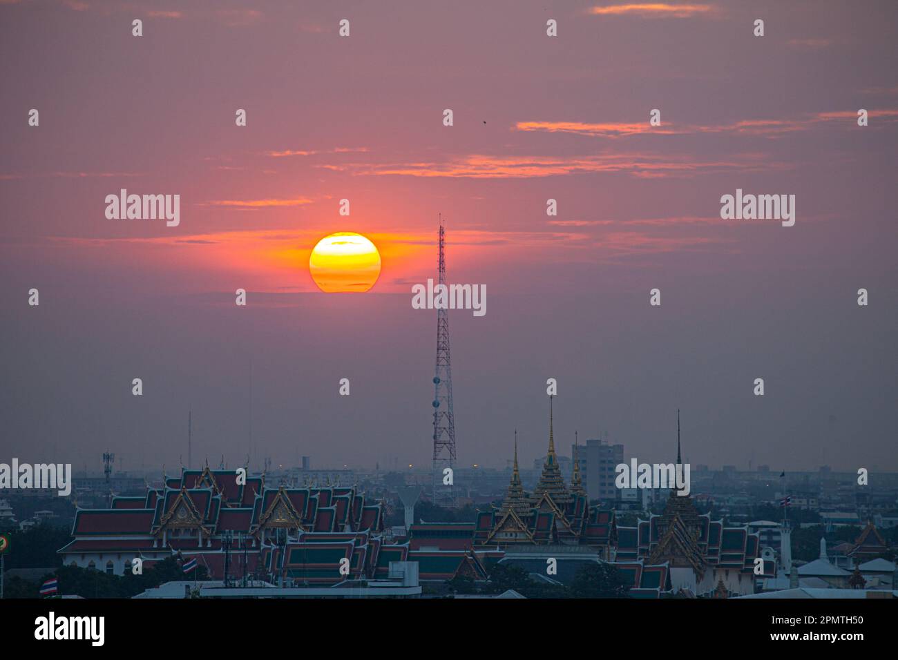 The red sun beside a huge signal tower in the heart of Bangkok ...