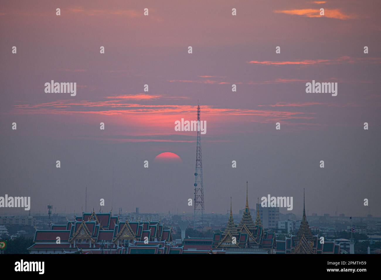 The red sun beside a huge signal tower in the heart of Bangkok ...
