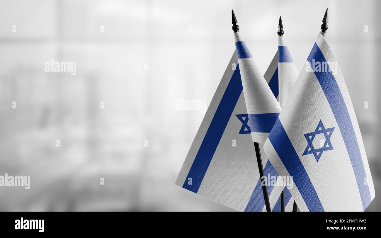 Small flags of the Israel on an abstract blurry background Stock Photo ...