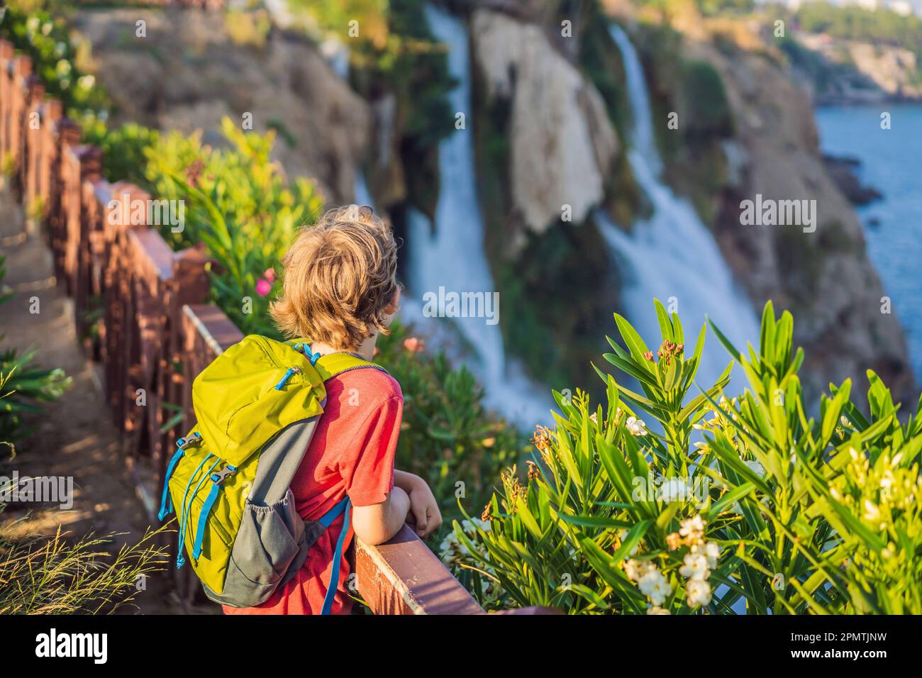 Boy tourist with a backpack on the background of Duden waterfall in ...
