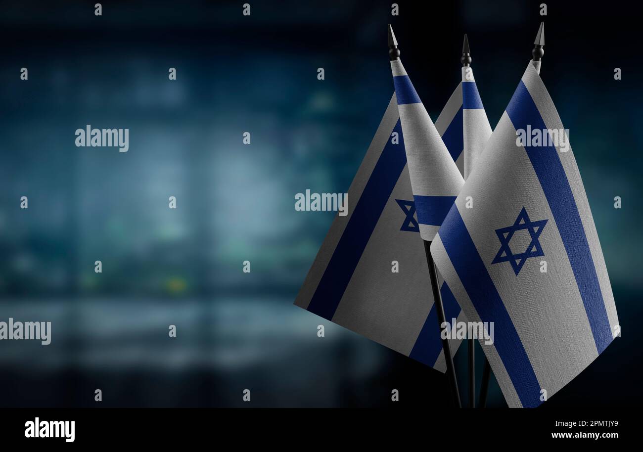 Small flags of the Israel on an abstract blurry background Stock Photo ...