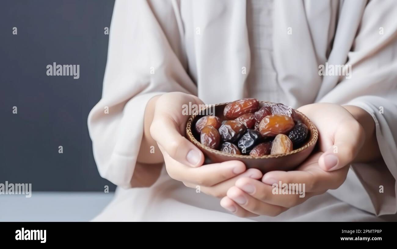 Muslim girl holding bowl of dates. Traditional distribution of food ...