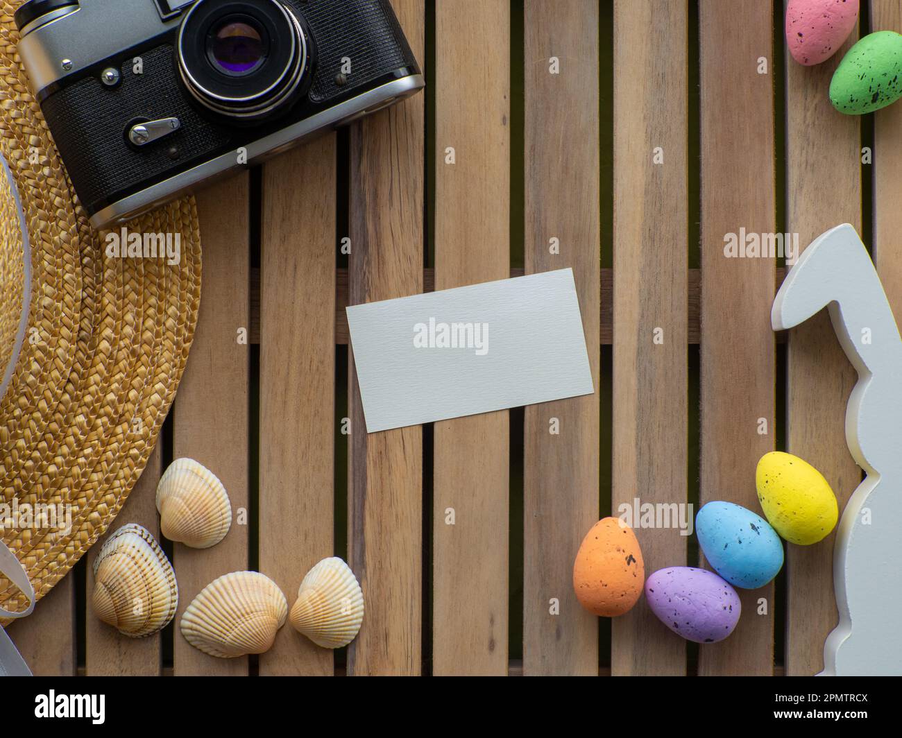 Easter background with straw hat, photo camera, colorful eggs and white ...