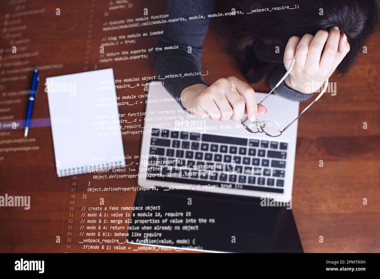 Programmer working on laptop computer and coding code on screen ...