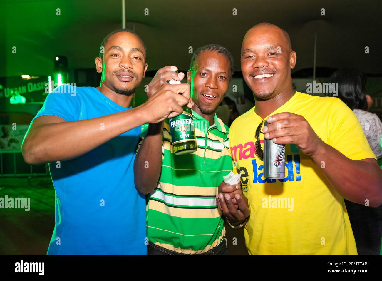 Three men enjoying themselves while sharing a few beers and laughing ...