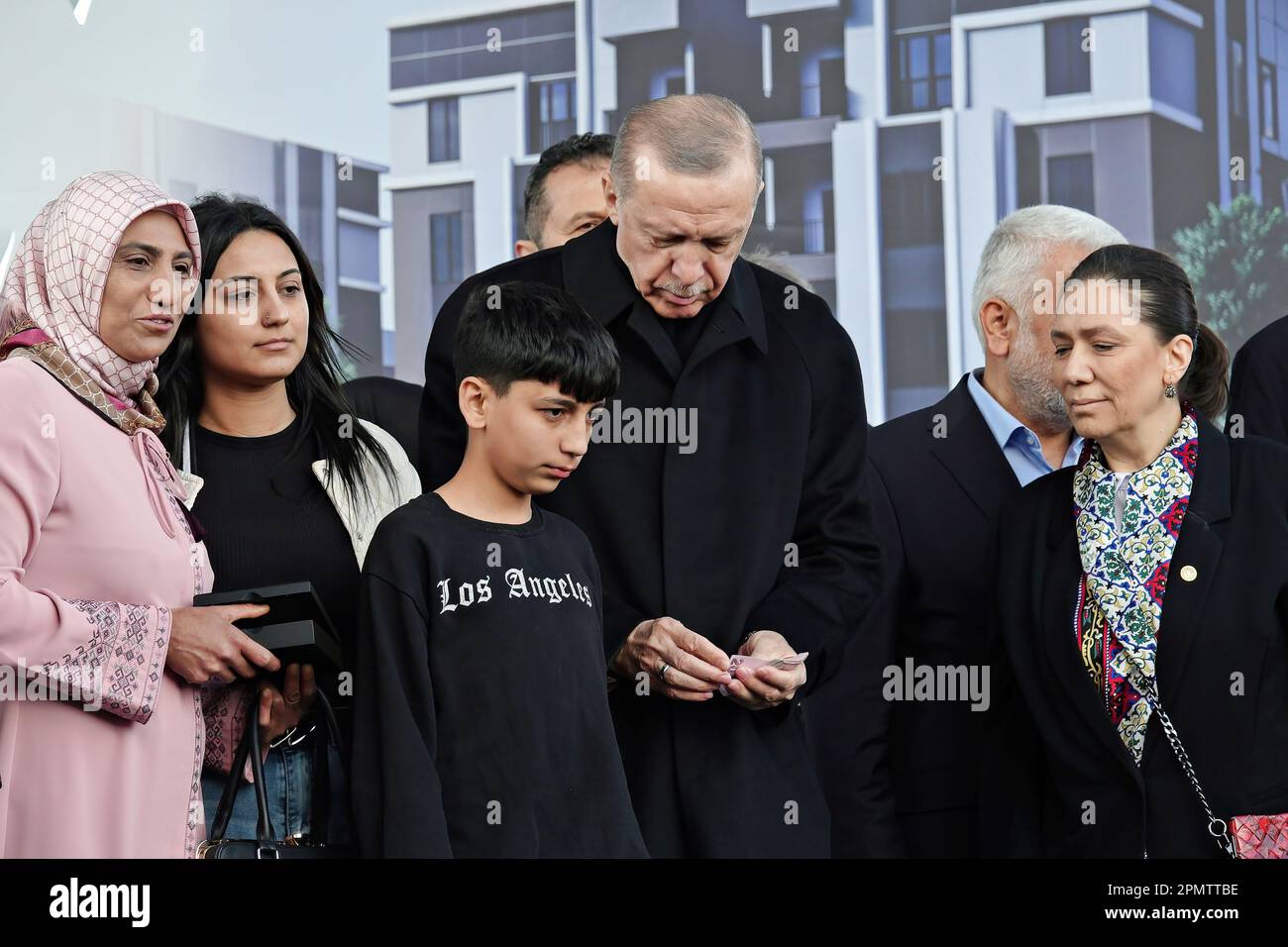 Turkish President Recep Tayyip Erdogan, is seen with the family that ...
