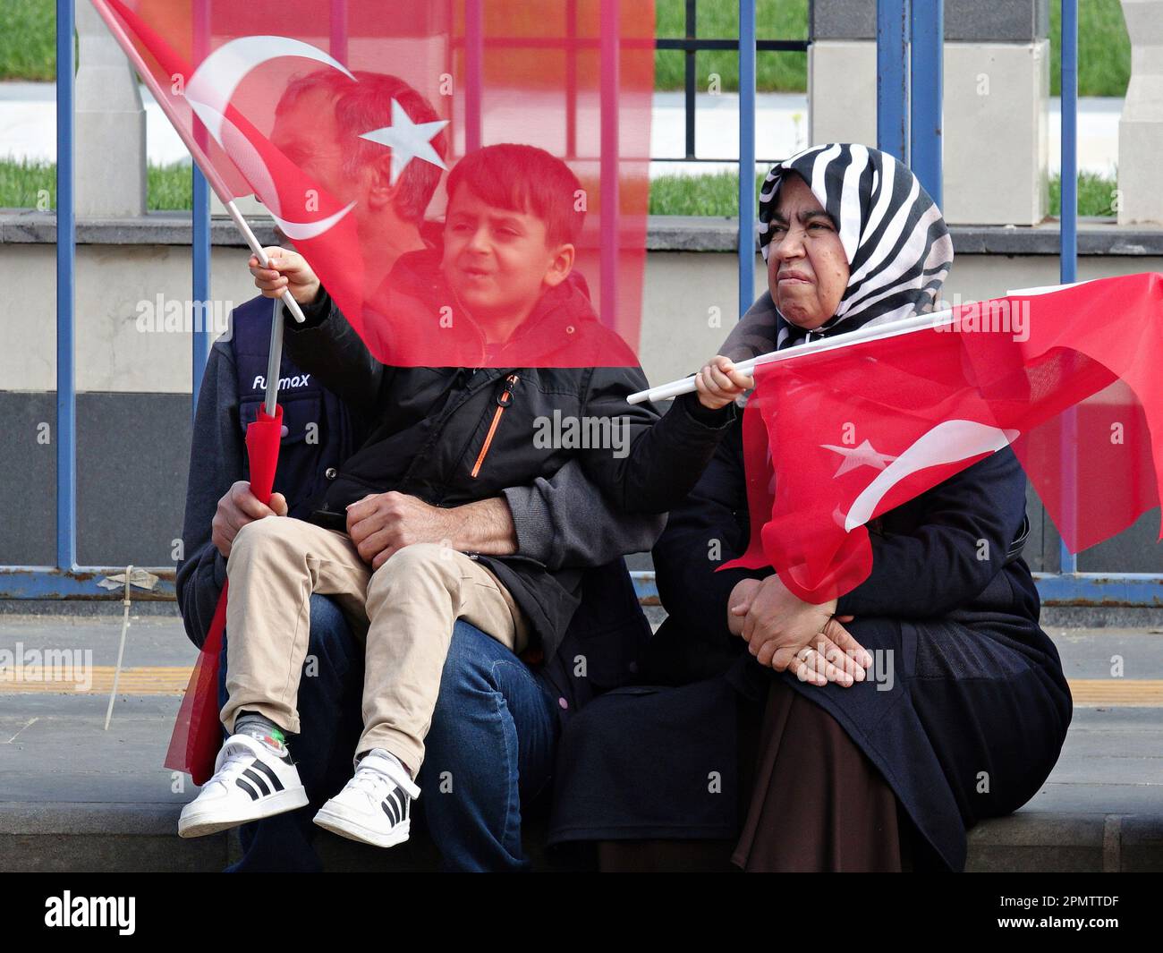 A family attends Turkish President Recep Tayyip Erdogan's rally with ...