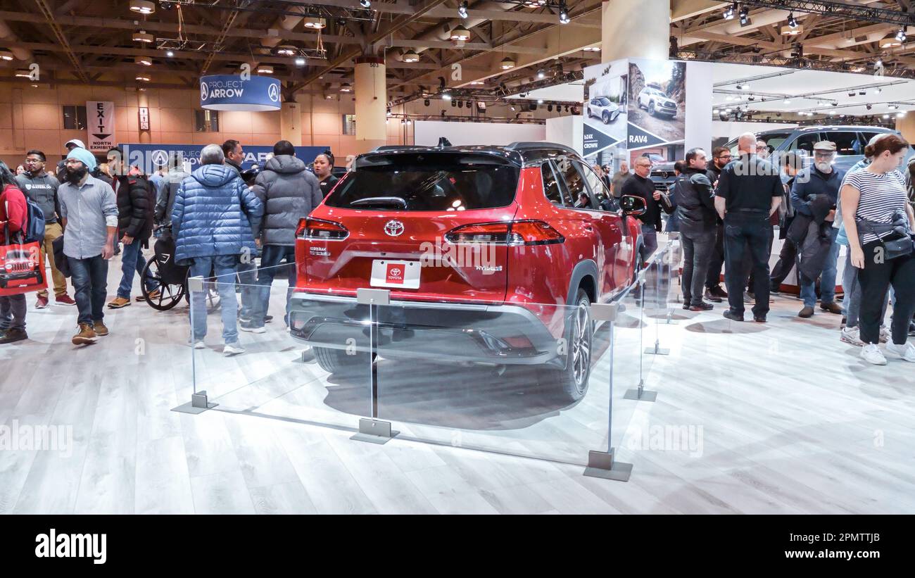 Crowds looking at new car models at Auto show. Toyota car on display ...
