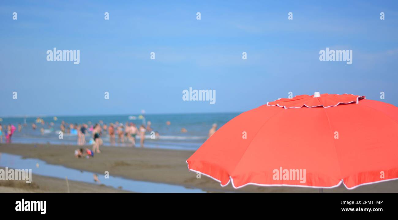 an open red beach umbrella in front of the sea Stock Photo - Alamy