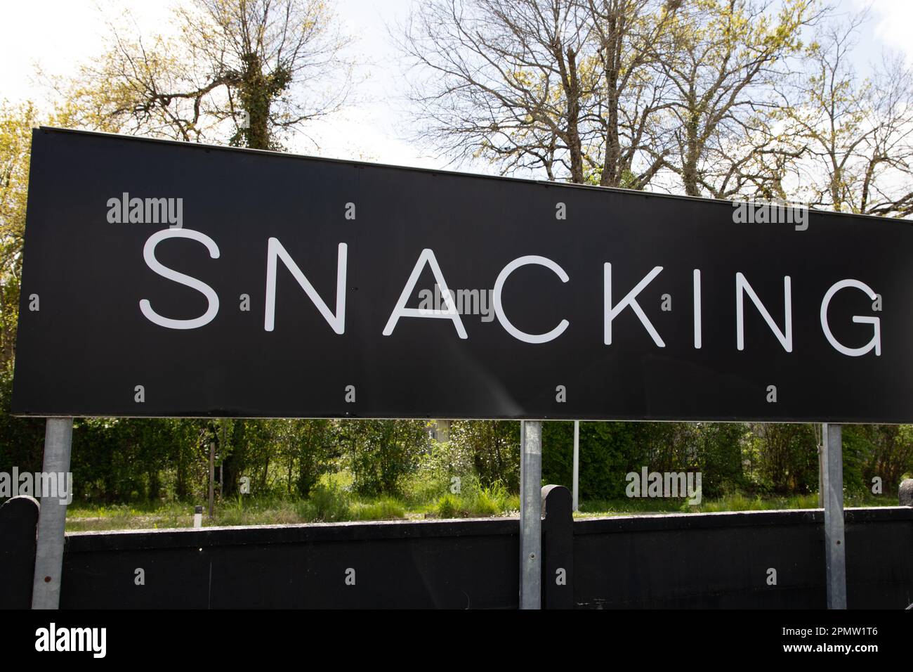 Snacking text sign fastfood restaurant entrance front of fast food take ...