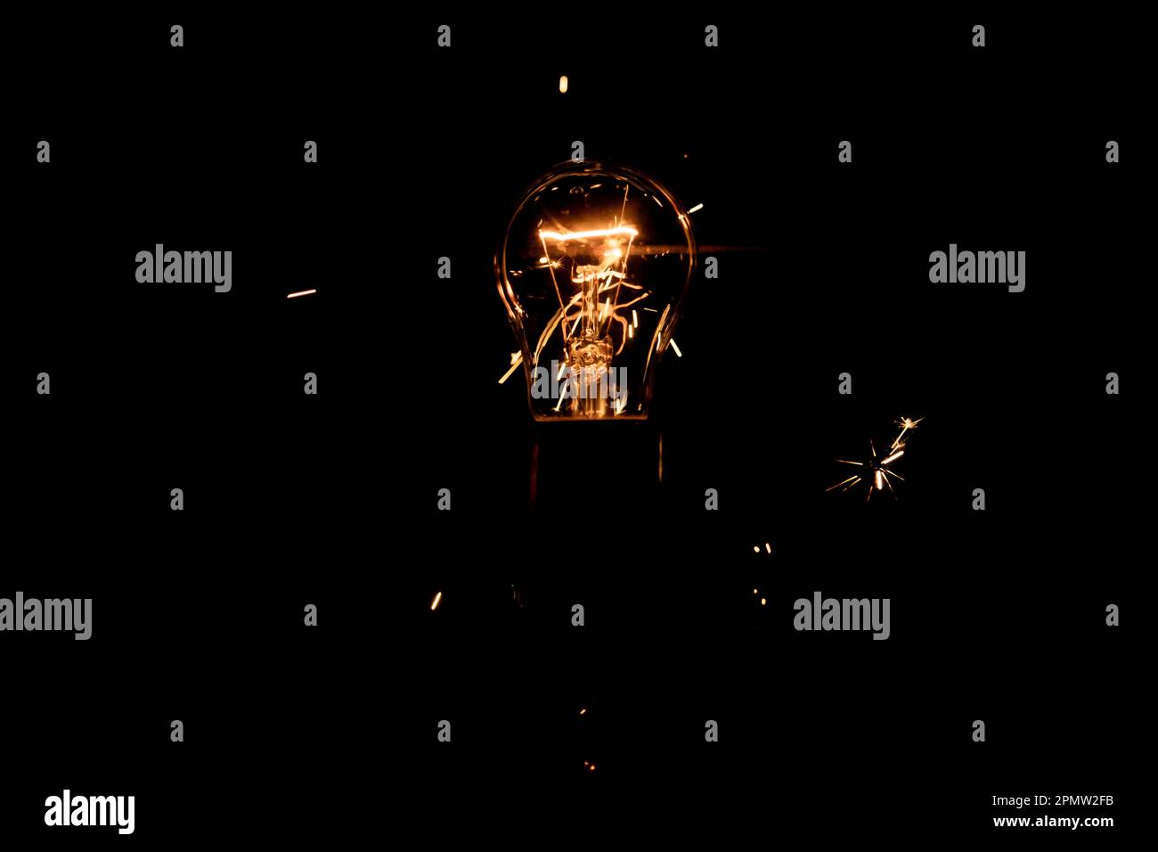 Light and sparks from a burning incandescent lamp. Short circuit Stock ...