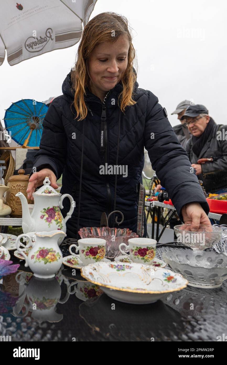 Dresden, Germany. 15th Apr, 2023. A stand operator sets up her stand at ...
