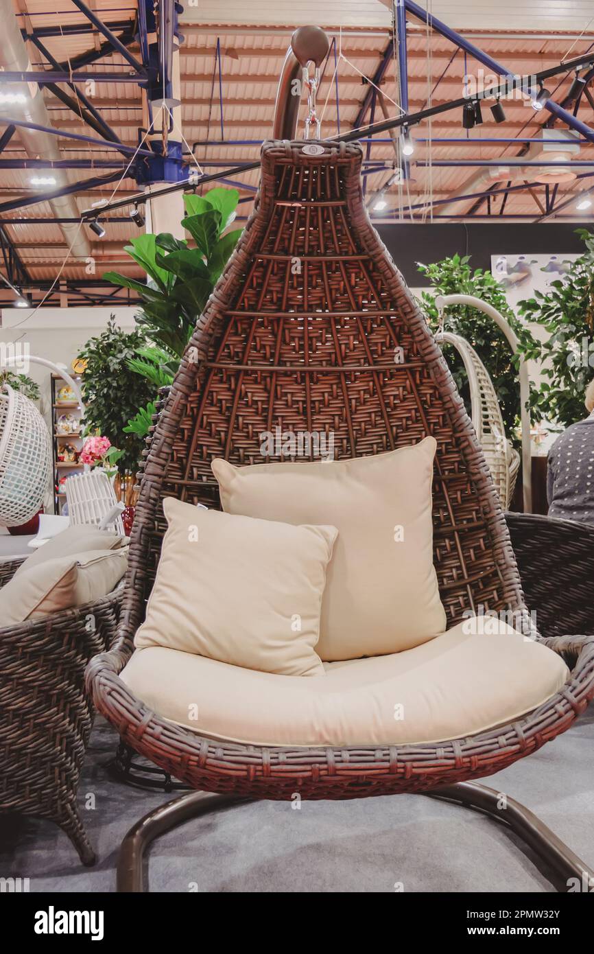 Hanging rattan garden chair with cushions Stock Photo - Alamy
