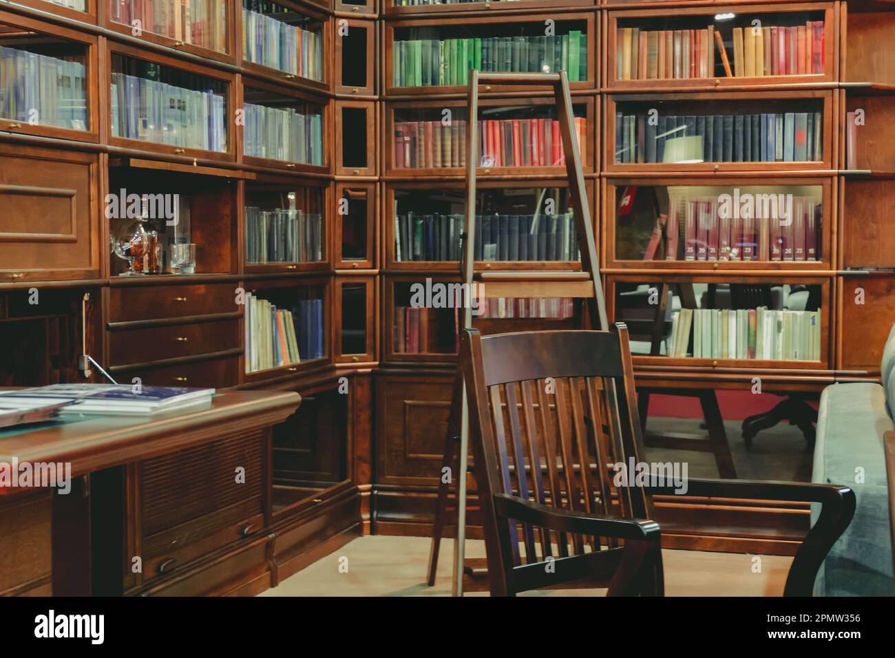 Study room with bookcases in brown style Stock Photo - Alamy
