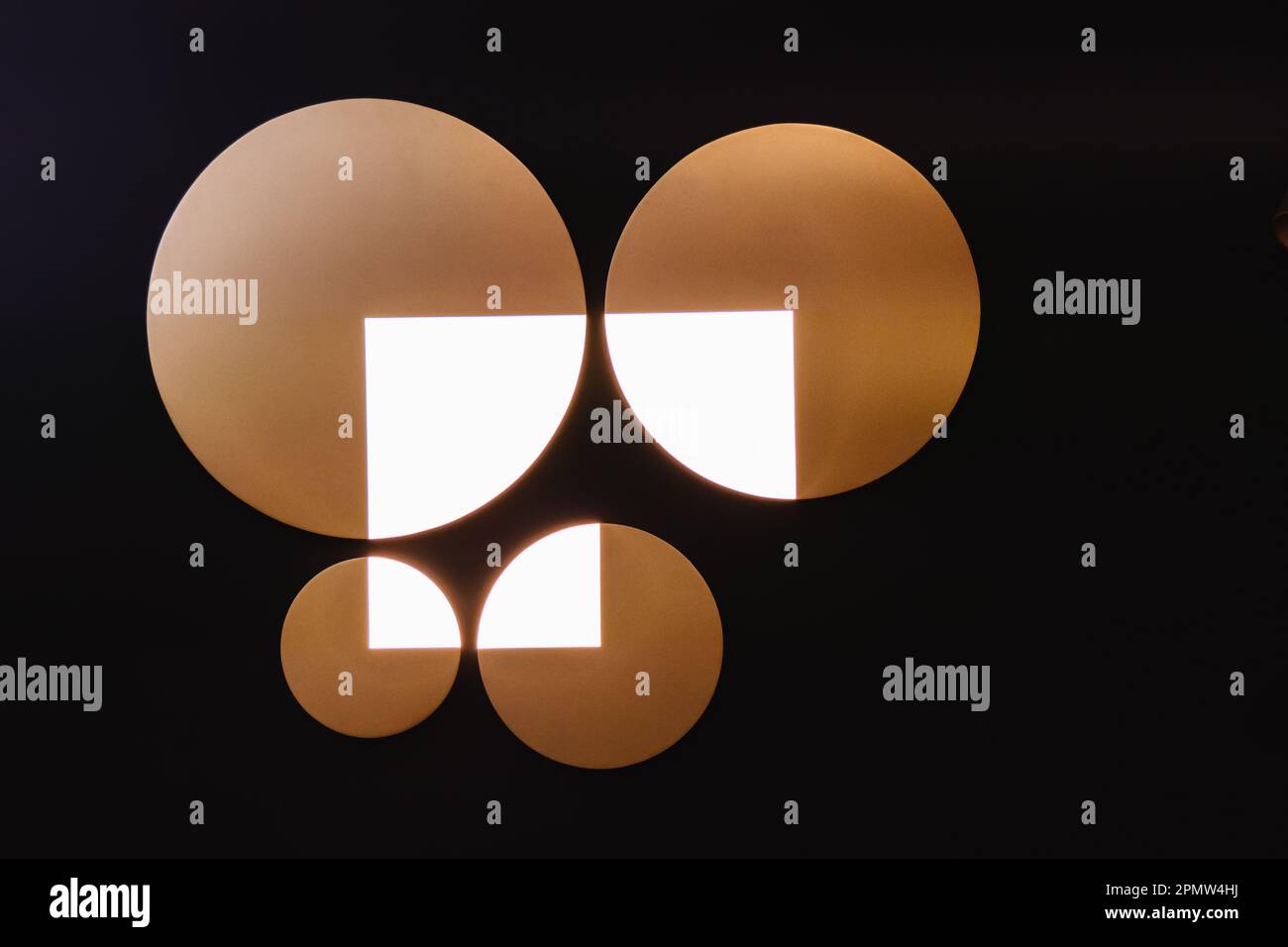 Four circles of different diameters and a light rectangle in the middle ...