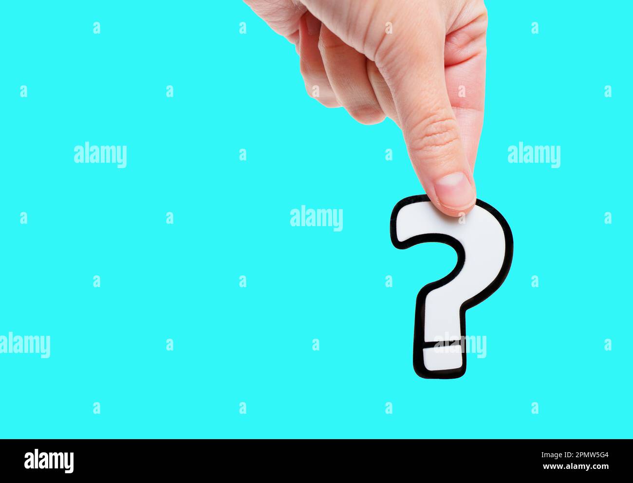 Large white question mark symbol in hand isolated on blue background ...