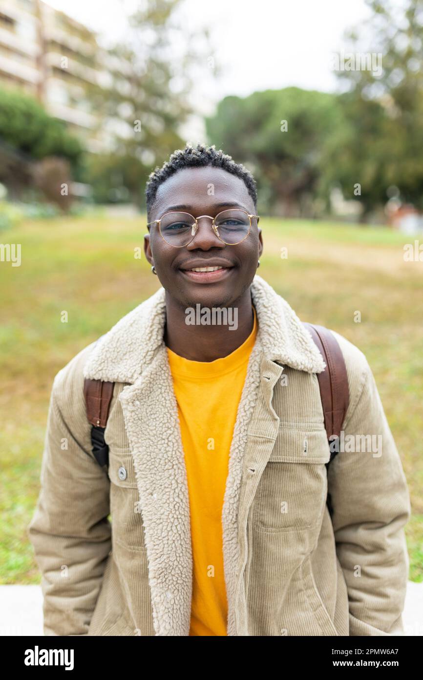 Vertical portrait of smiling high school african student man outdoors ...