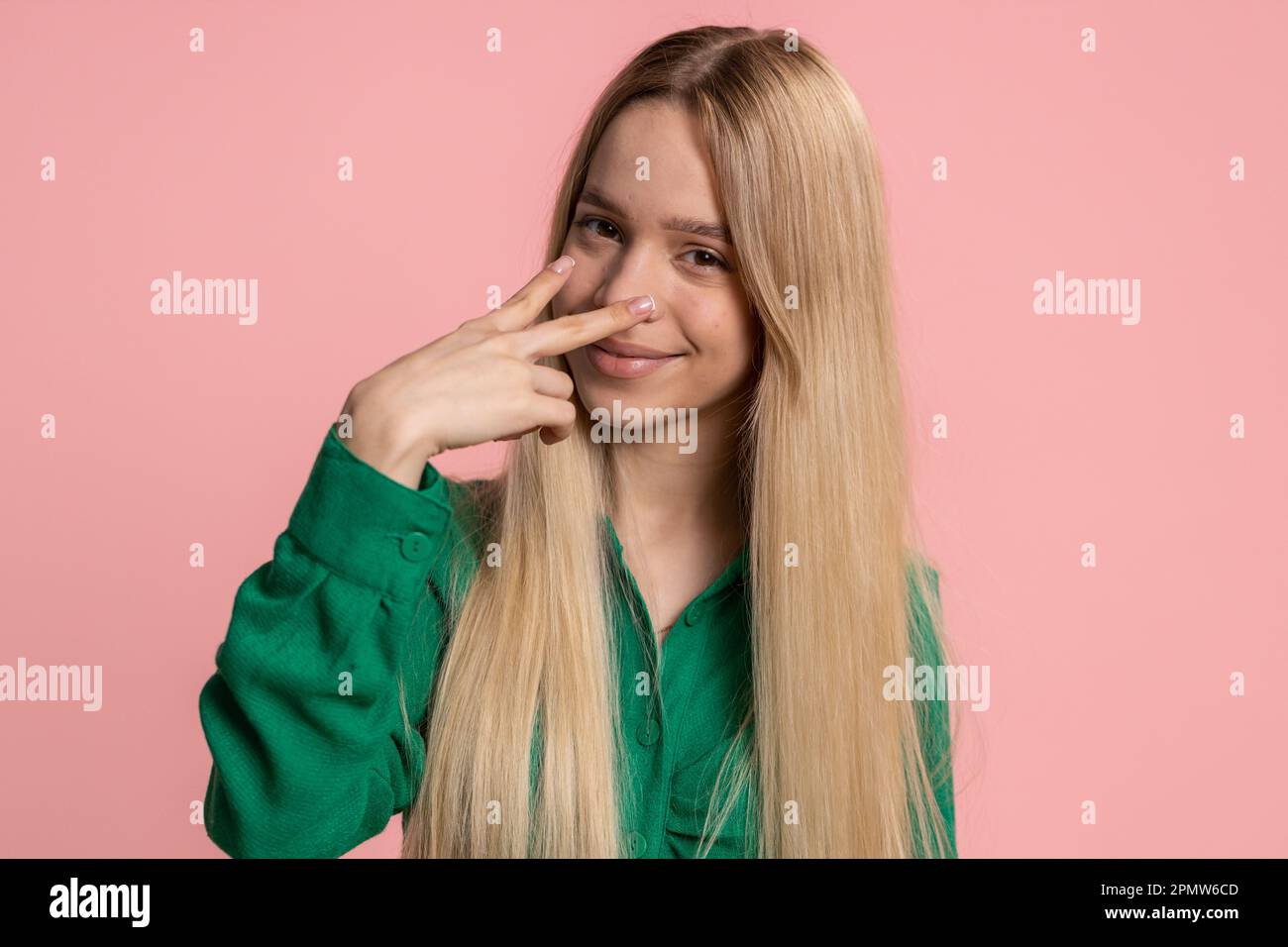I am watching you. Young confident caucasian woman pointing at her eyes ...