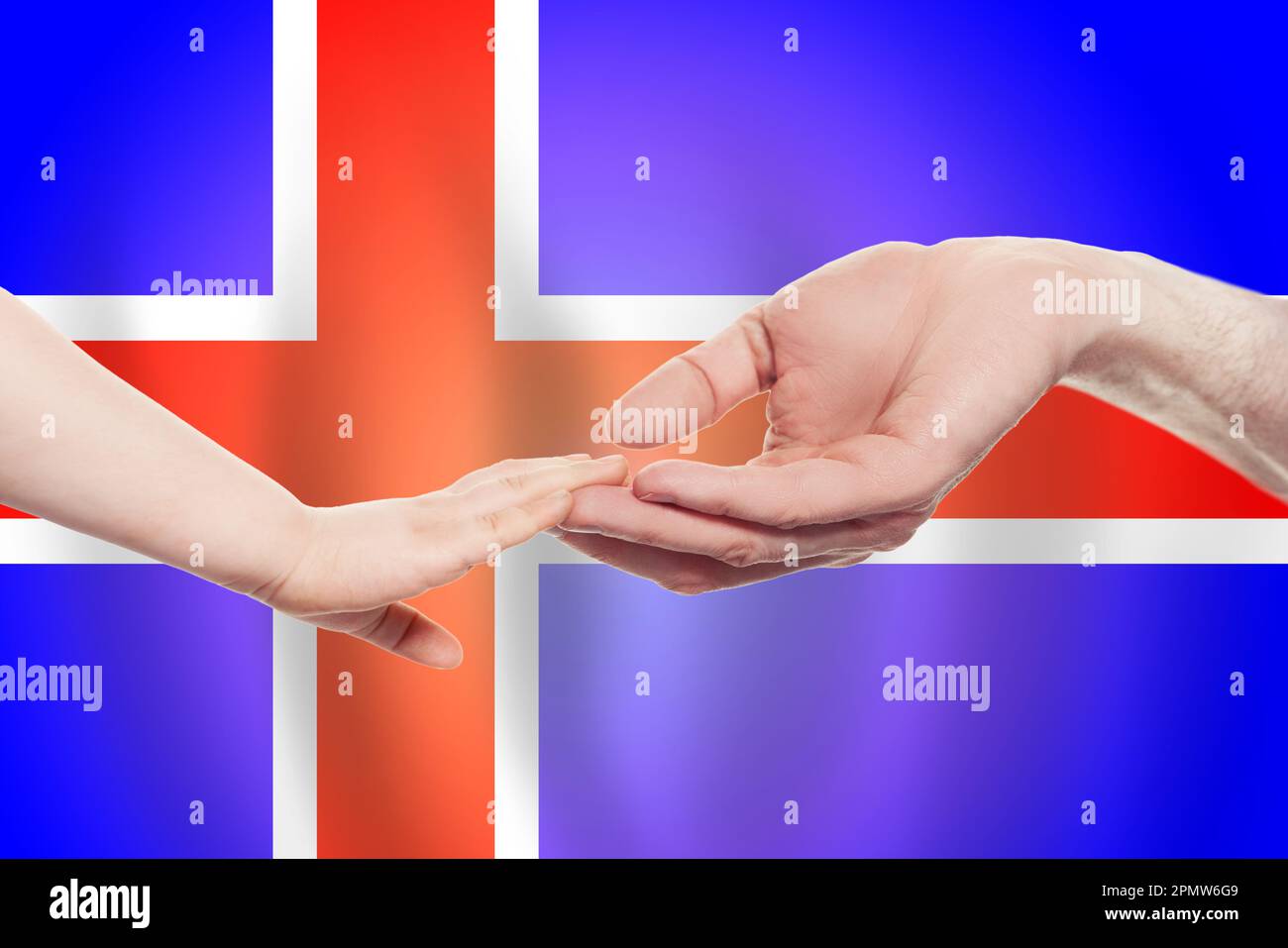 Icelandic baby and parent hands on the background of flag of Iceland Help, aid, support, charity ...