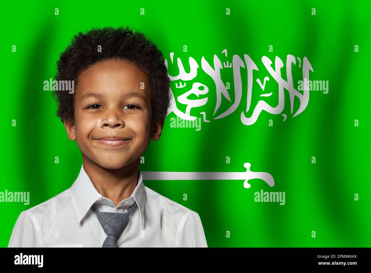 Saudi Arabian kid boy on flag of Saudi Arabia background. Education and ...