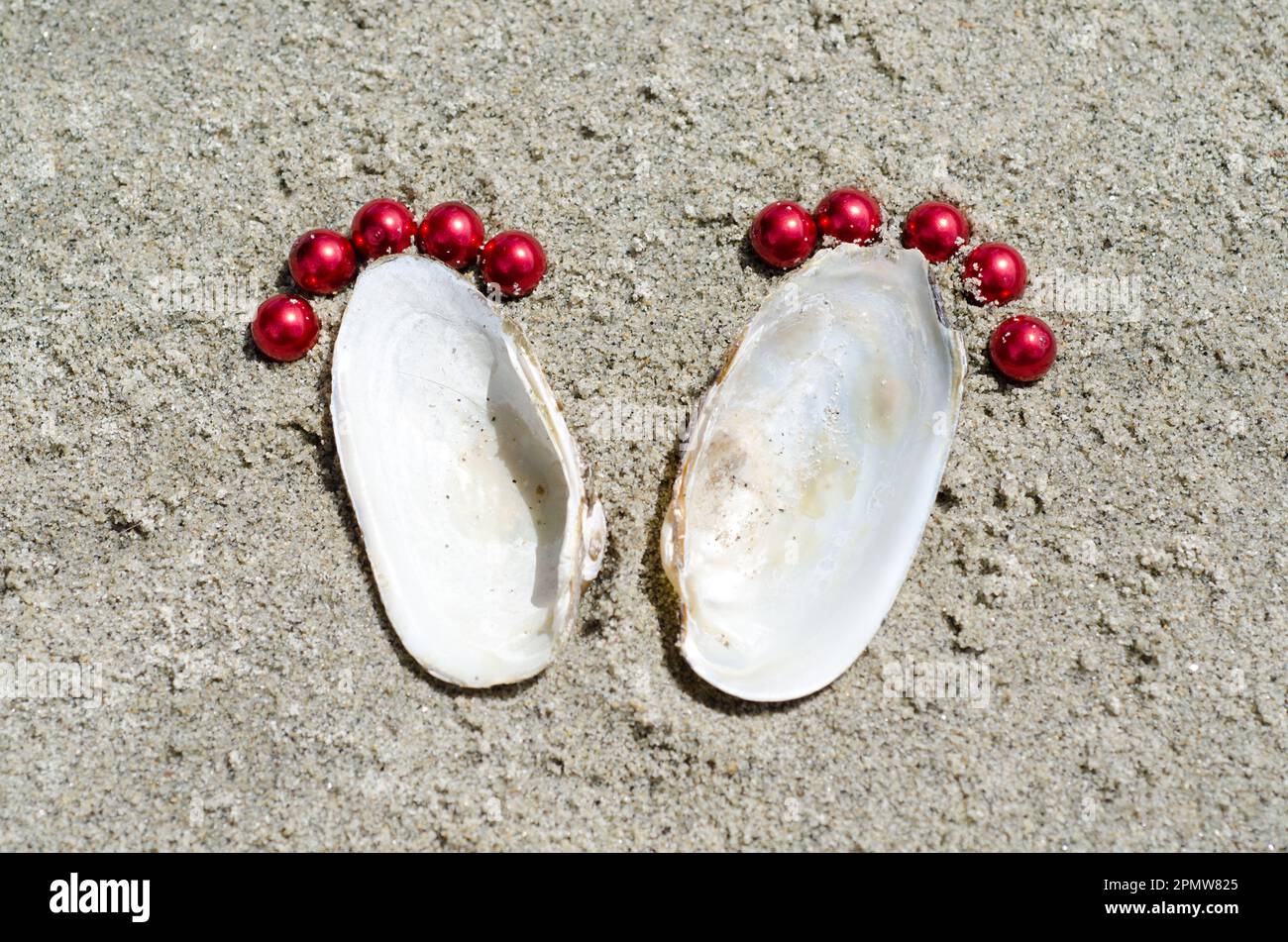 Footprints Made of Shells and Pearls in the Sand Stock Photo - Alamy