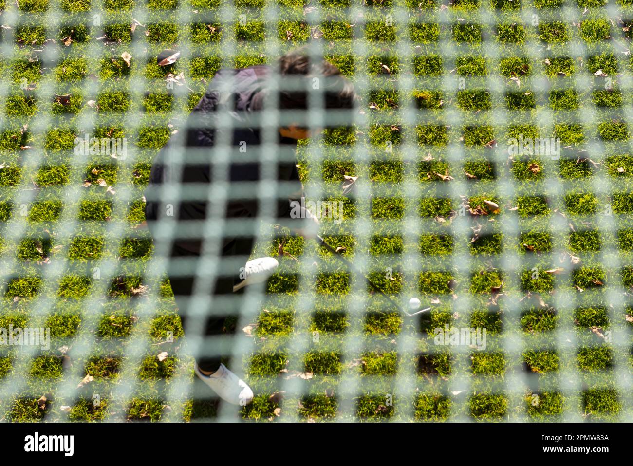 Golfer Training on Driving Range Behind a Net Stock Photo - Alamy