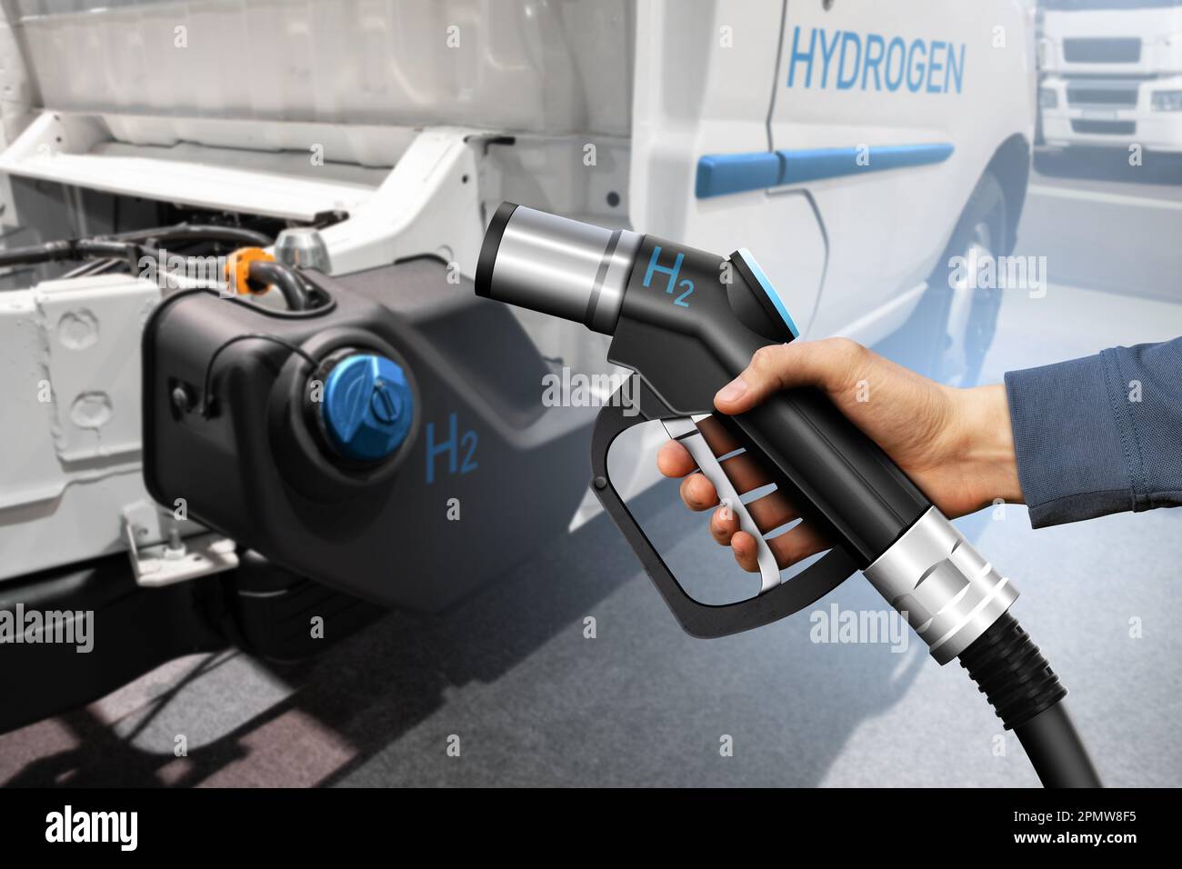 Hand with H2 fueling nozzle on a background of hydrogen fuel cell truck ...